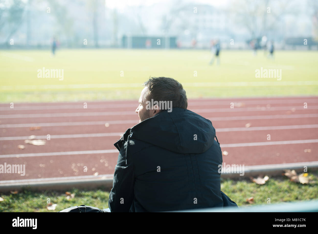 Back View of Young Man Sitting on Seat or Bleachers Sports Tribune and ...