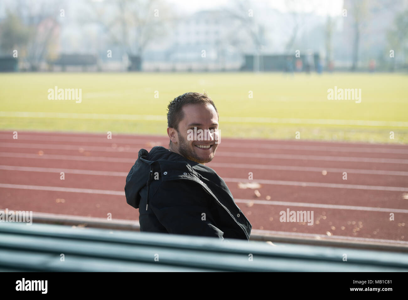 Back View of Young Man Sitting on Seat or Bleachers Sports Tribune and ...