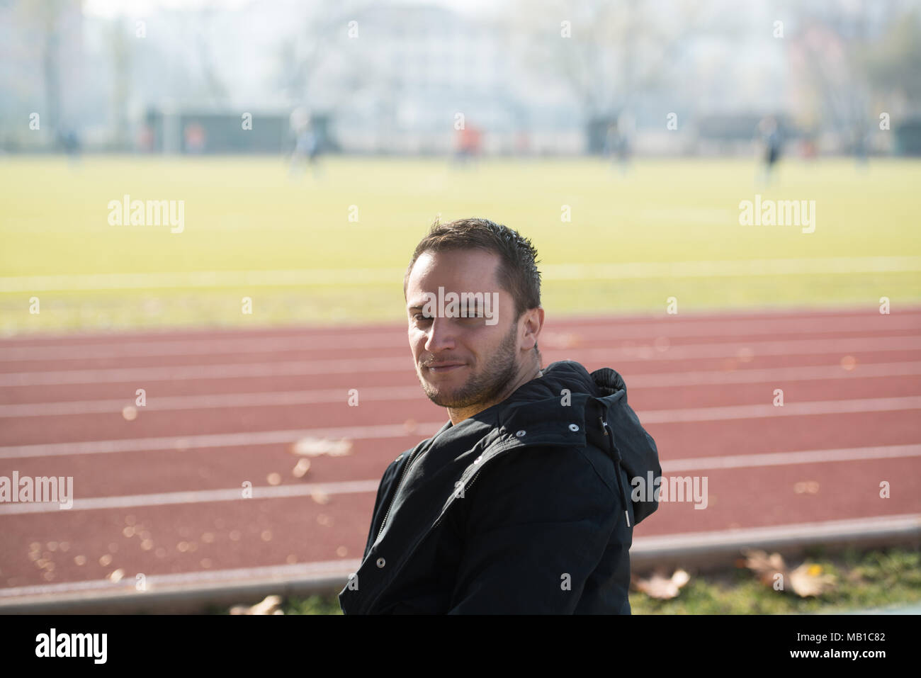 Back View of Young Man Sitting on Seat or Bleachers Sports Tribune and ...