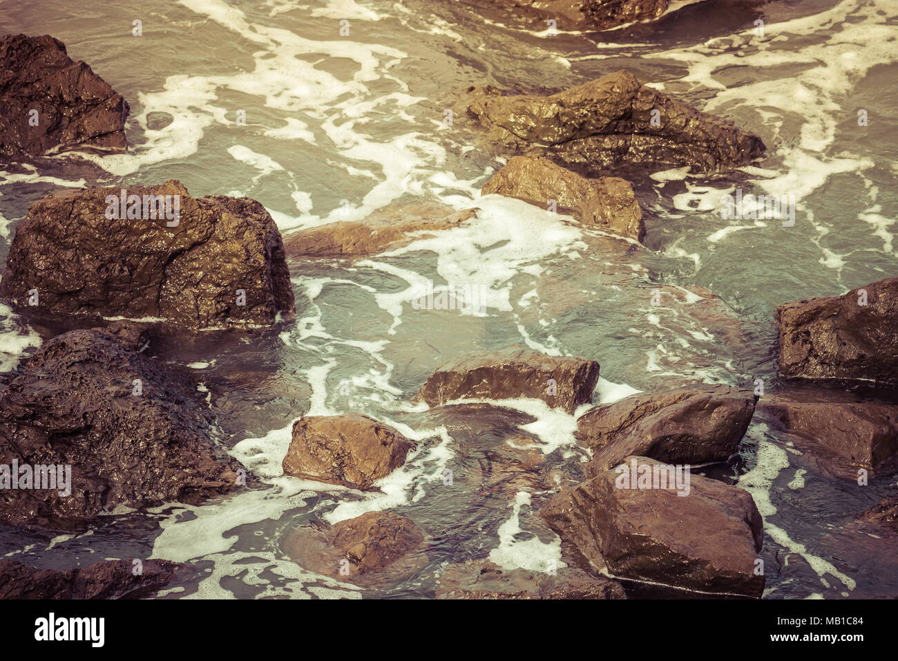 Close up image of rocks on a coastal shore with ocean water Stock Photo ...