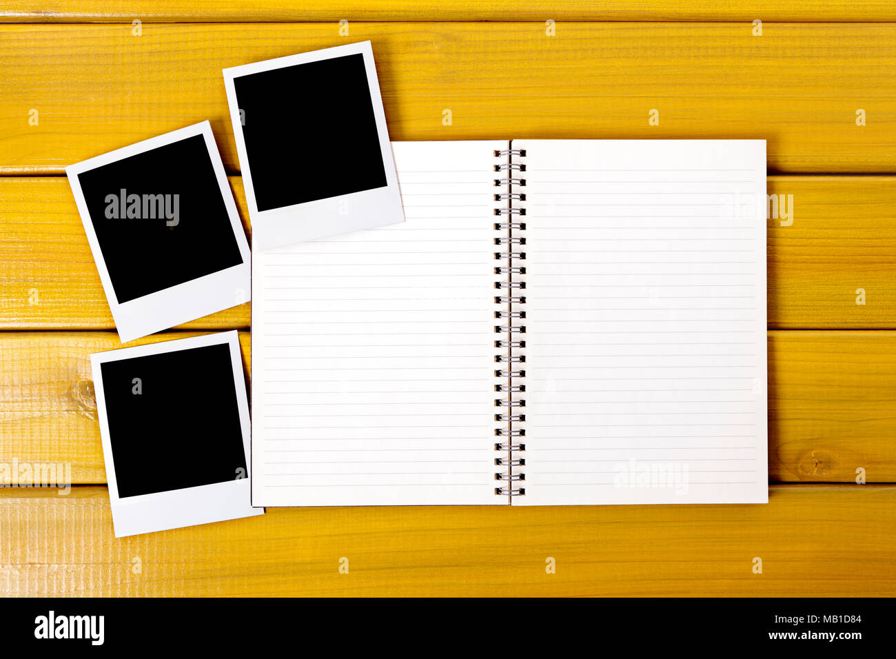 Photo album or notebook with three blank photo prints. Space for copy ...