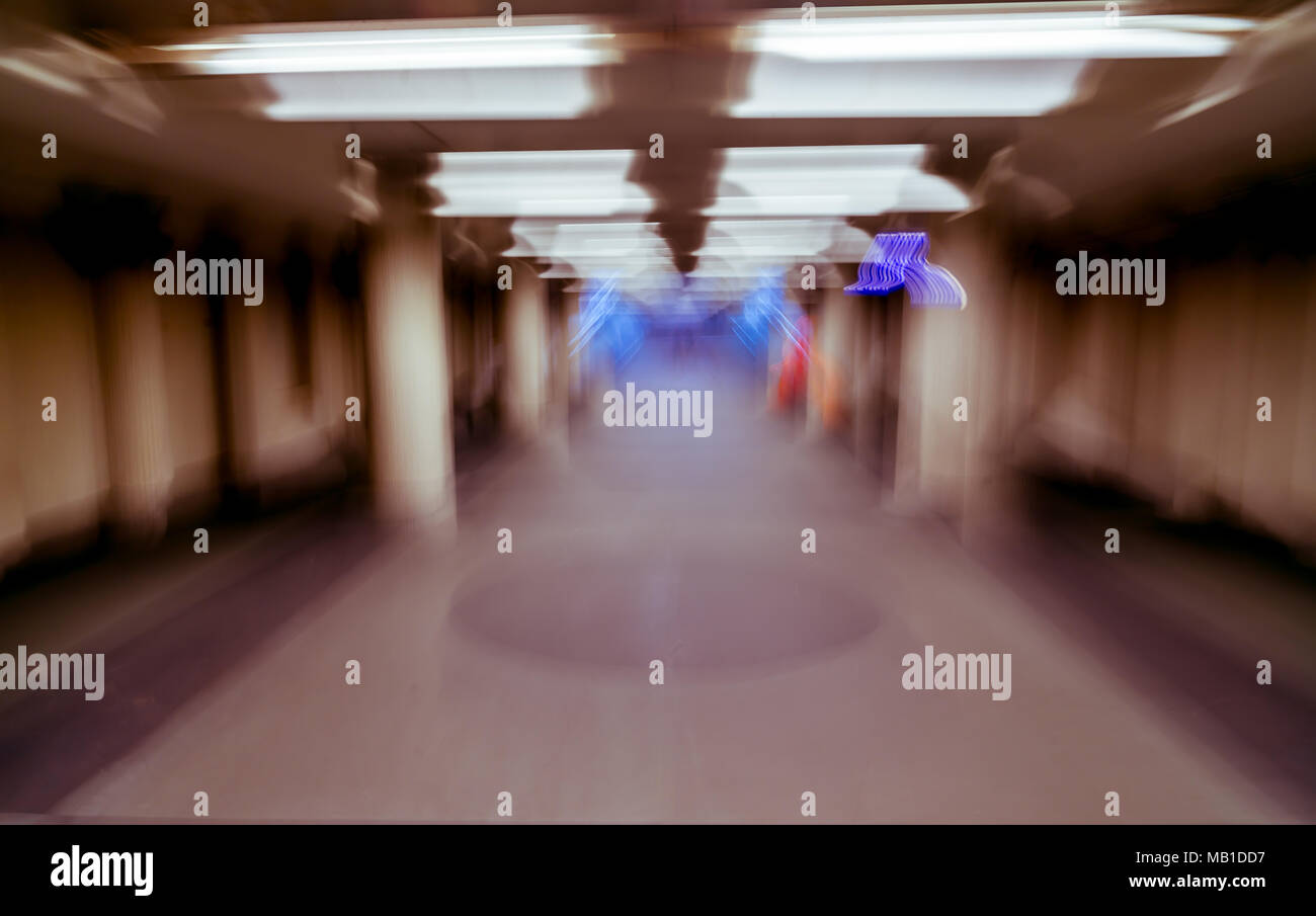 Ghostly blurred effect inside a long dark structural pathway Stock ...