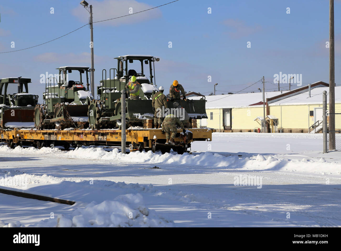 Soldiers prepare military equipment on railcars for shipment Feb. 7 ...