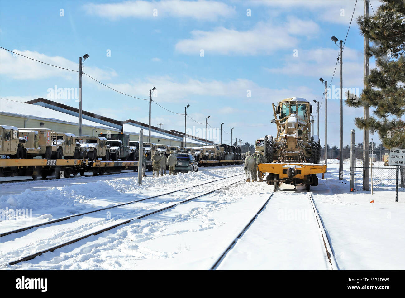 Soldiers prepare military equipment on railcars for shipment Feb. 7 ...