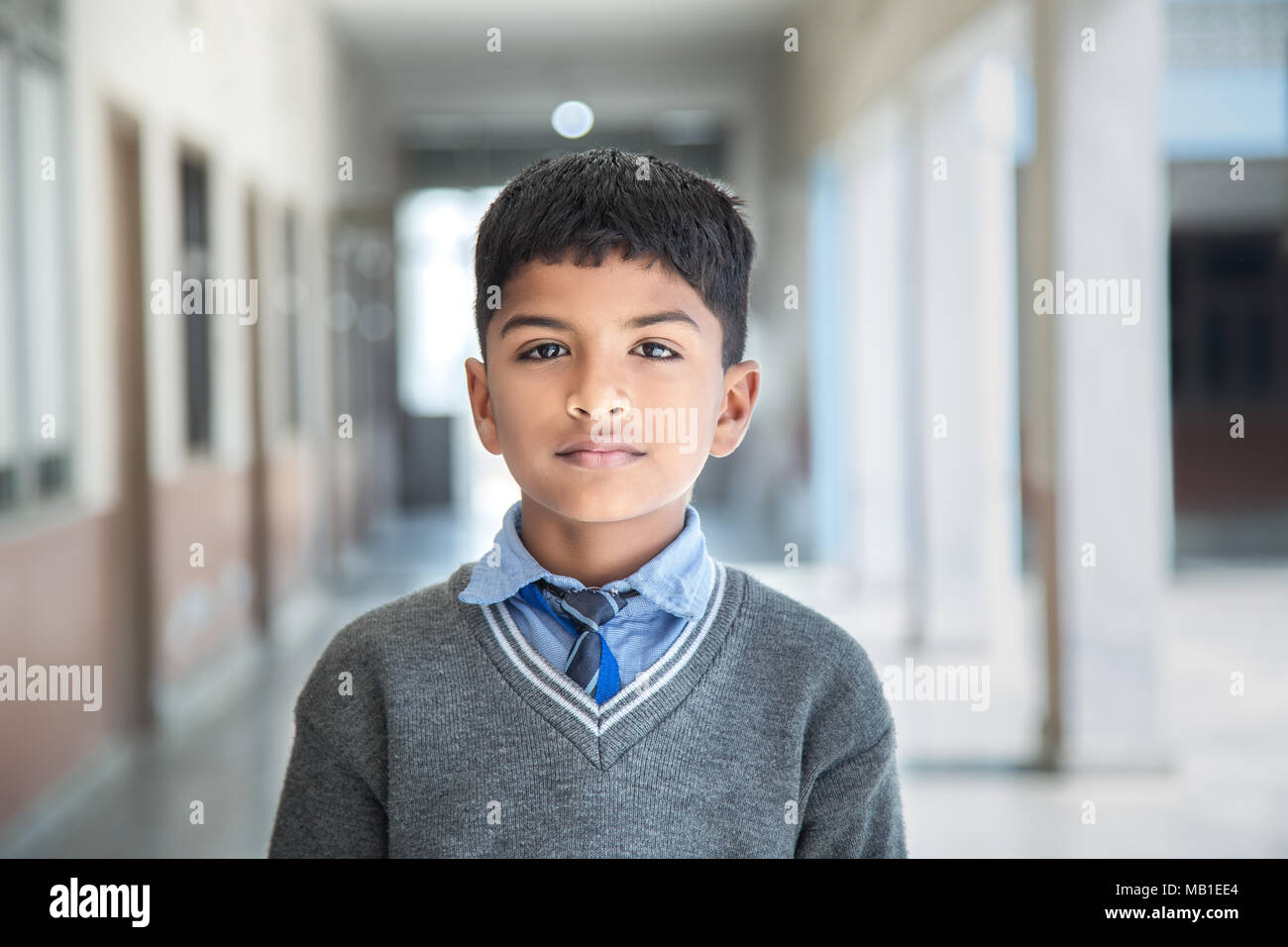Closeup portrait of smiling 6-7 years Indian kid, standing straight at ...