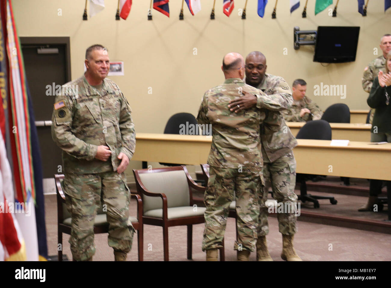 Command Sgt. Major Levi Maynard congratulates incoming commander Maj ...