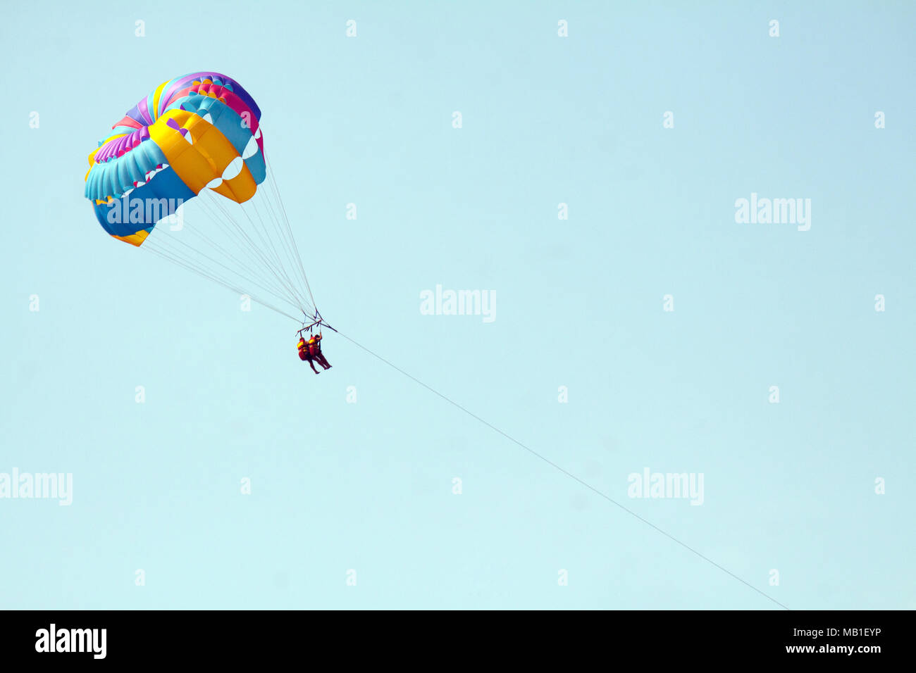 Parasailing in a blue sky Stock Photo - Alamy