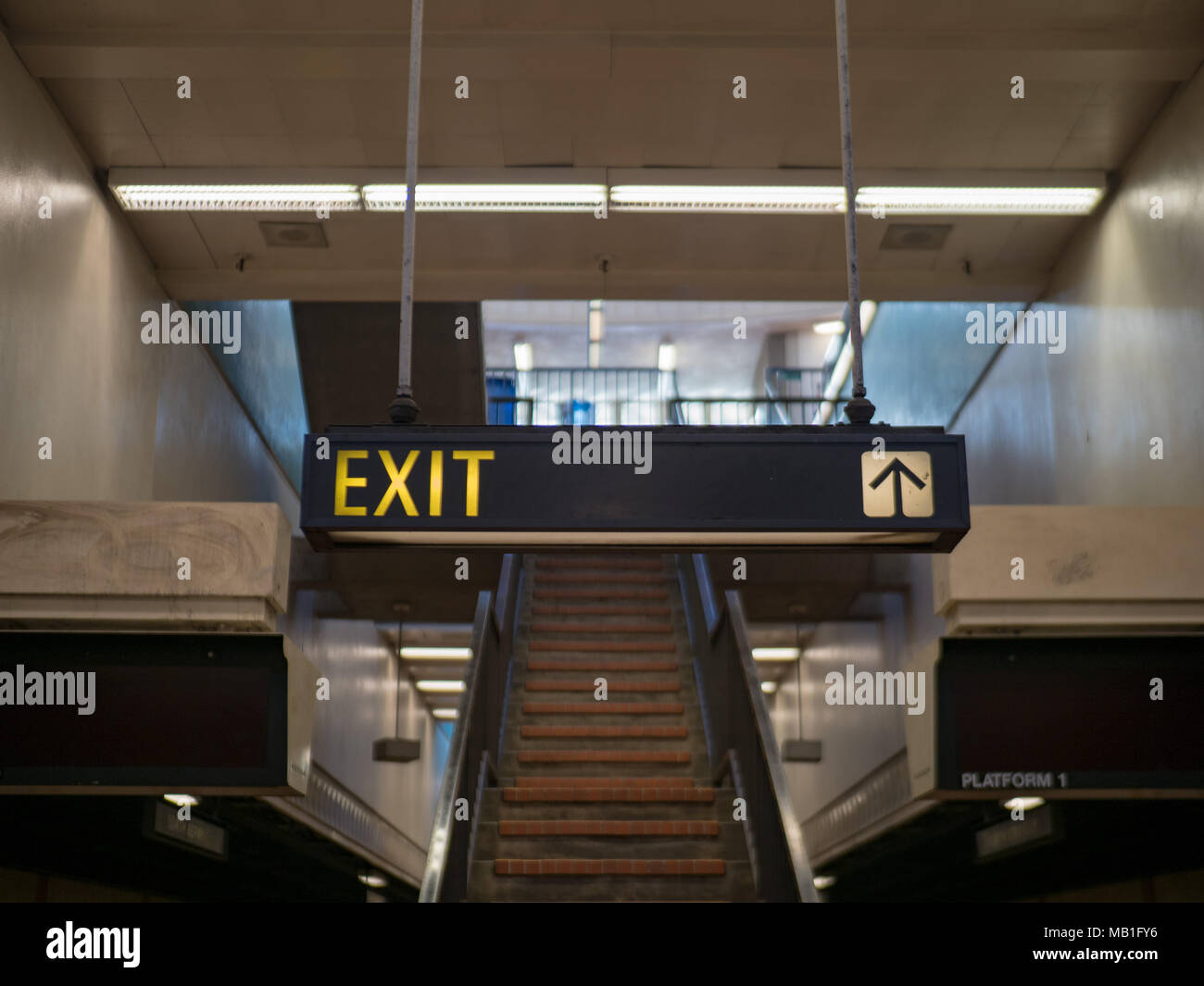 Exit sign in a dark tunnel with stairs leading up to the exit Stock ...