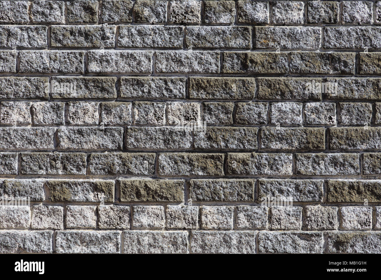 Brick wall made of grey and dirty white bricks. Front view Stock Photo ...