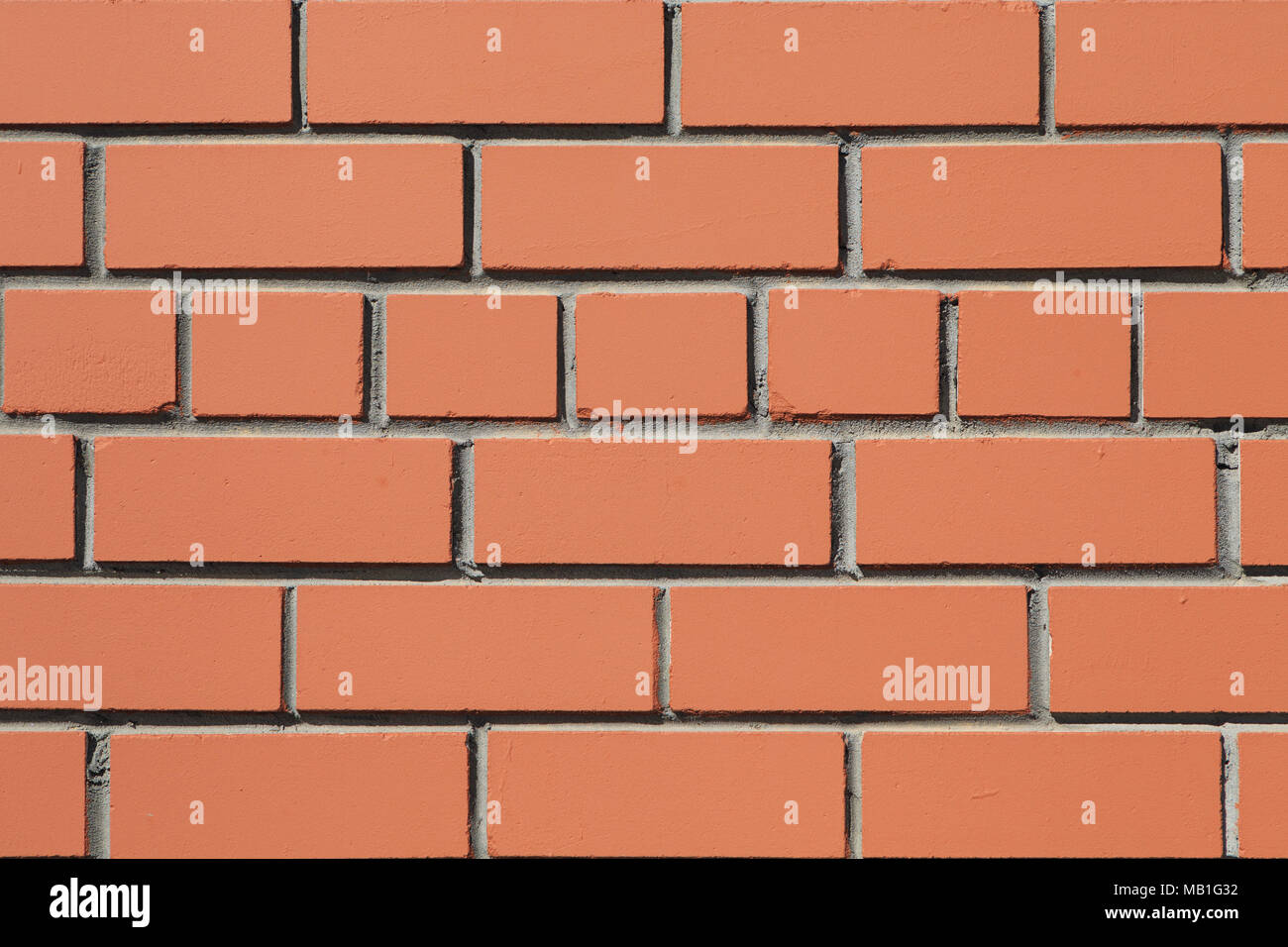 Front close-up view of a flat brick wall with the bricks symmetrically ...
