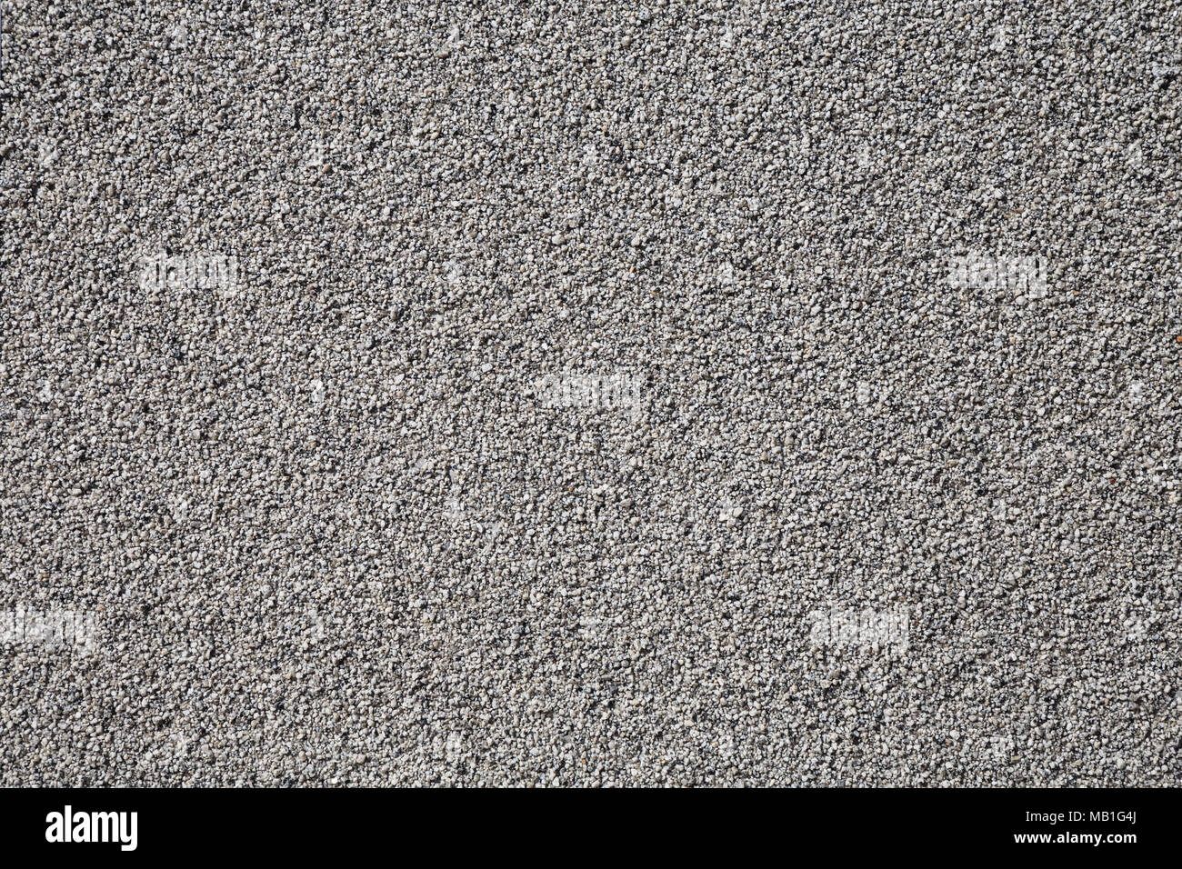 Grey wall made of very small pebble evenly spread around it Stock Photo ...
