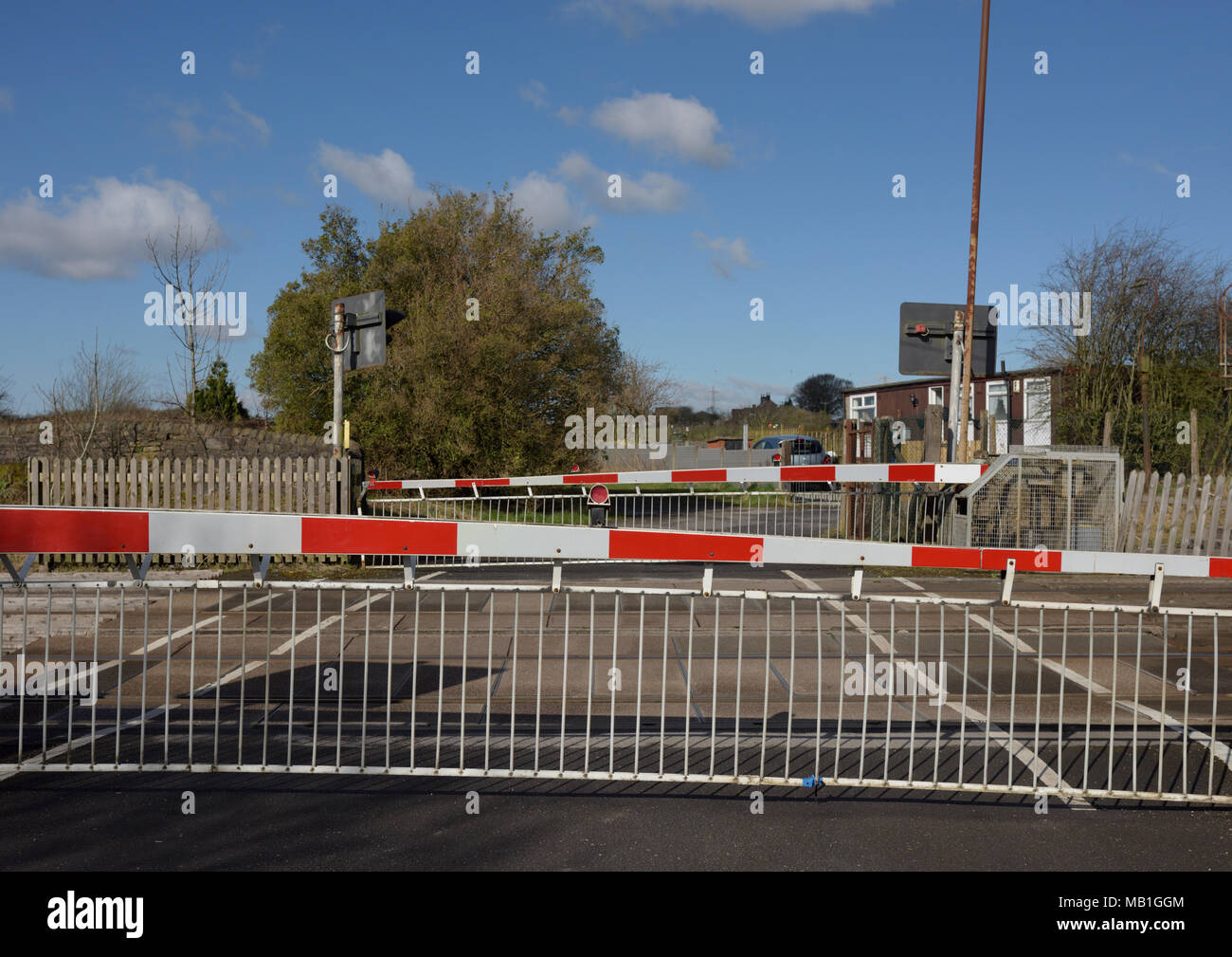 Level crossing gates closed at Manchester metrolink tram level crossing ...