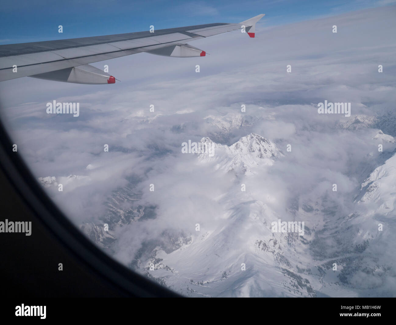Wing of an airplane flying over alps hi-res stock photography and ...
