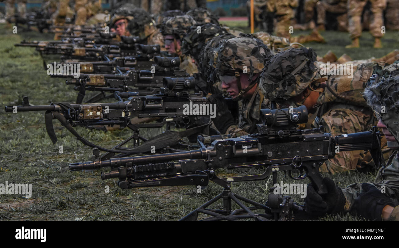 A line of heavy machine guns is assembled as paratroopers from the ...