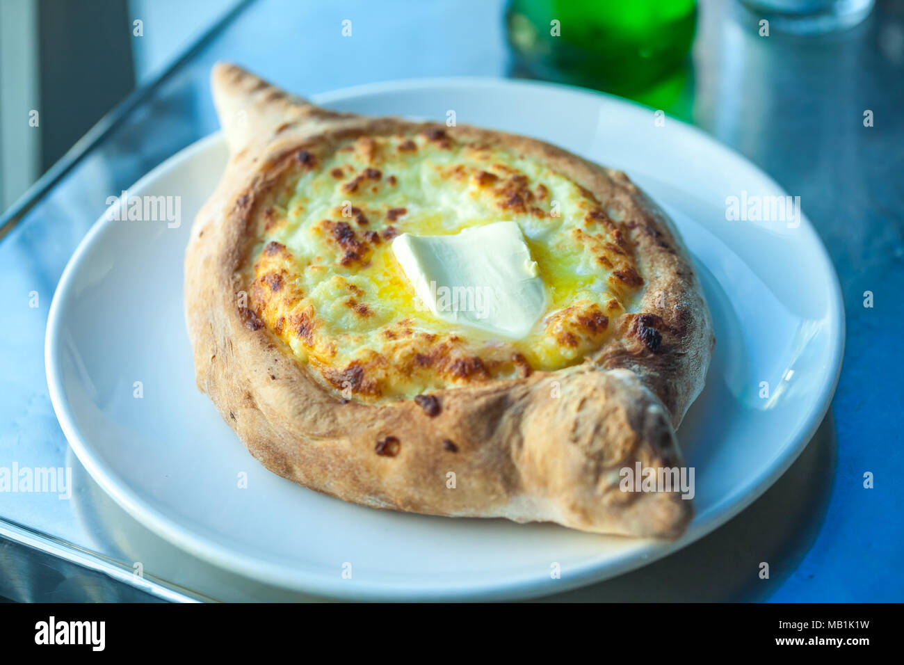 Adjarian khachapuri with eggs on the table. Traditional Georgian ...