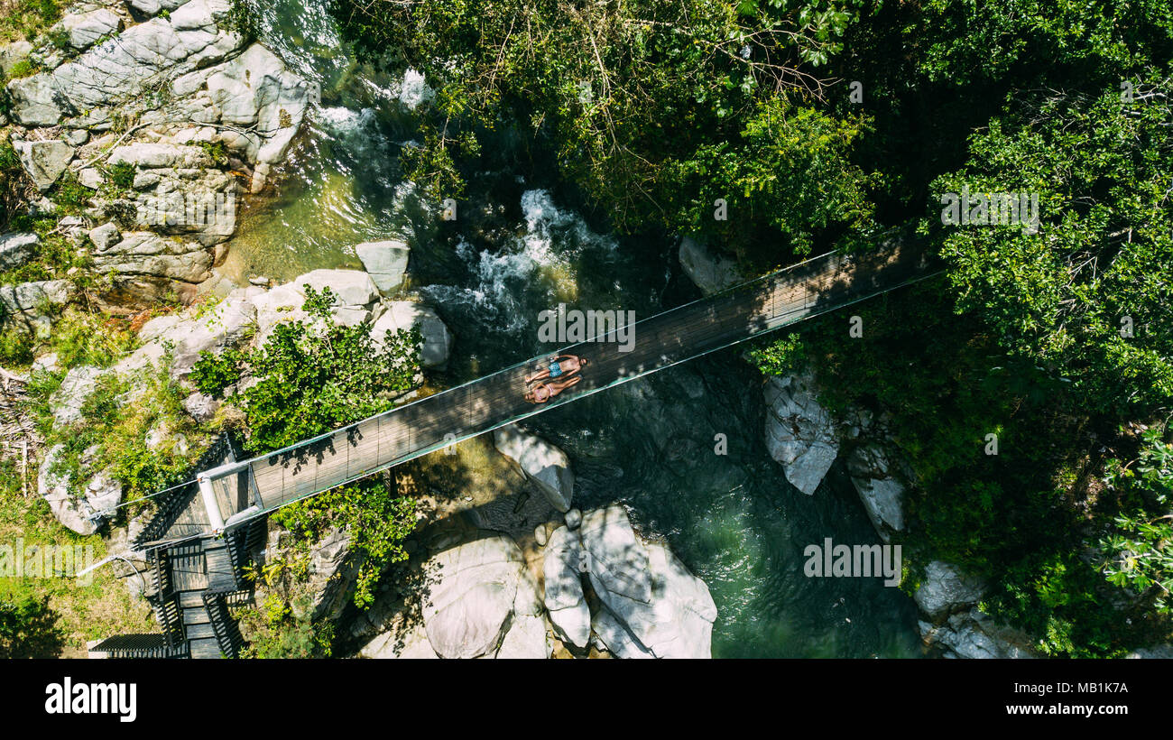 Bridge under river. Two people close Stock Photo - Alamy