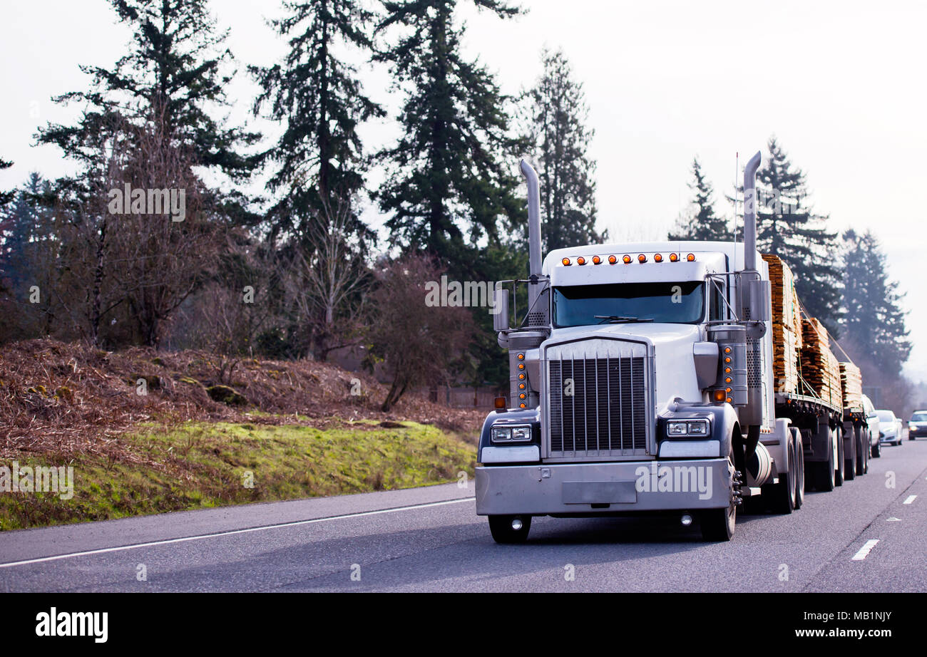 Big rig classic powerful semi truck with tall pipes and illumination ...