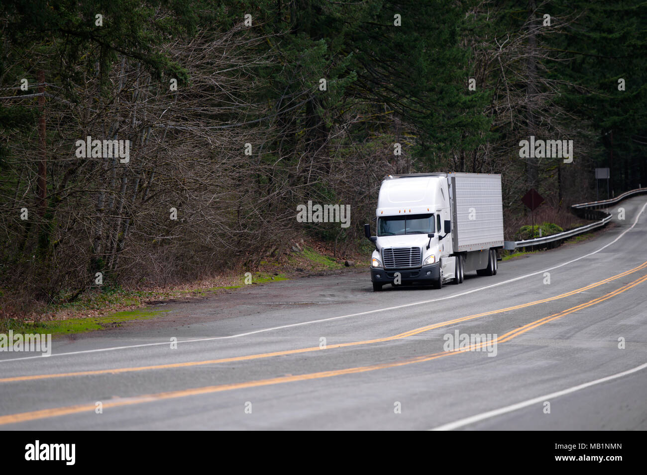 Big rig white bonnet semi truck with reefer semi trailer stand out of ...