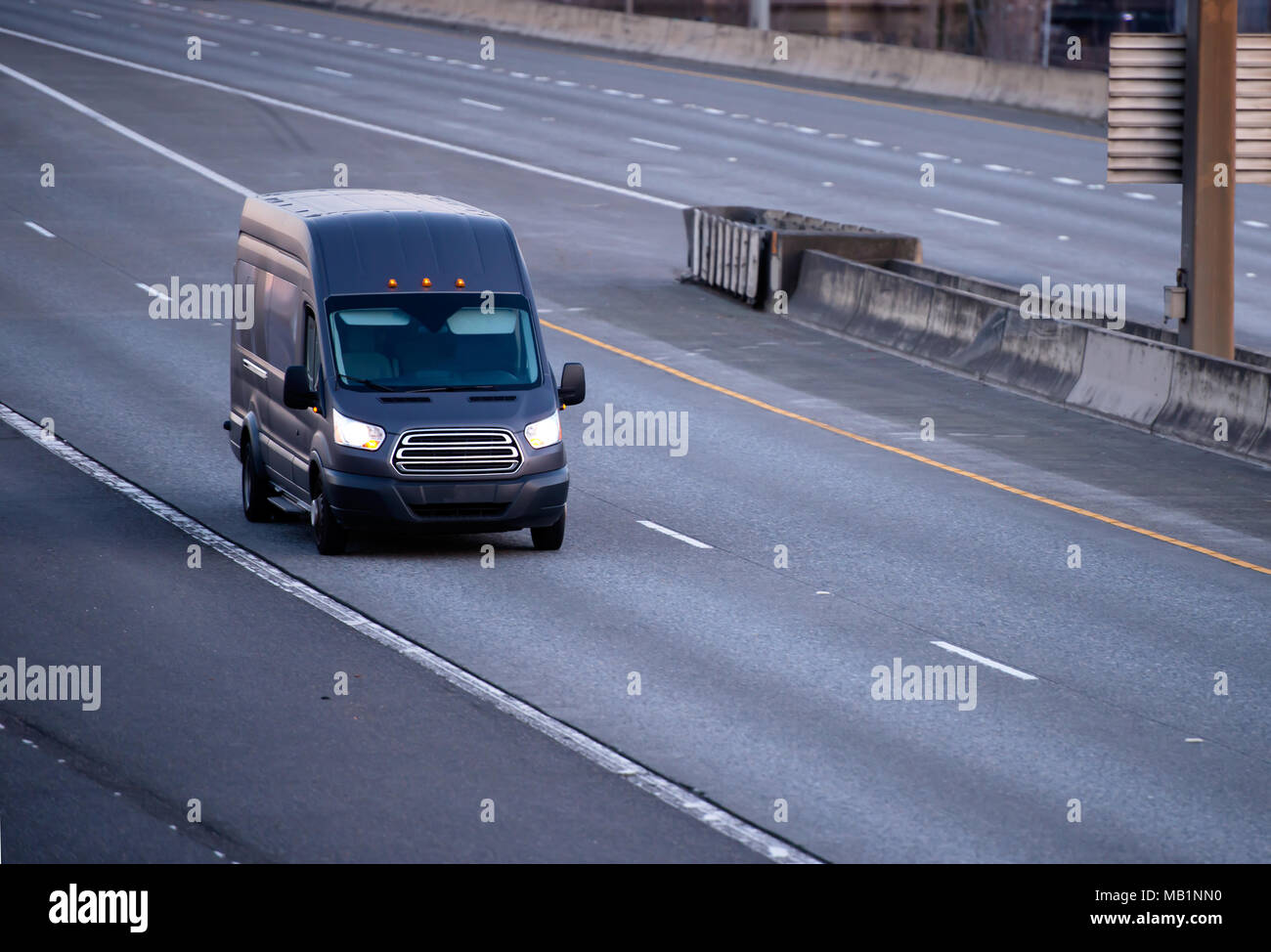 Black compact commercial useful small business cargo mini van running ...