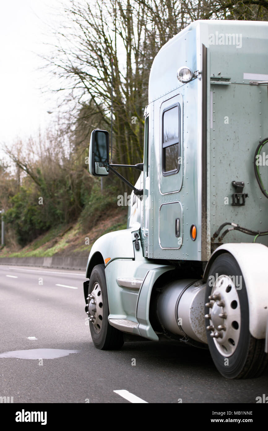 Classic light green big rig powerful semi truck tractor with ...