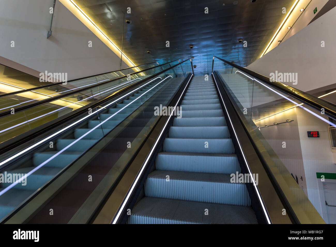 Mechanical escalators with white linear lights inside a building Stock ...