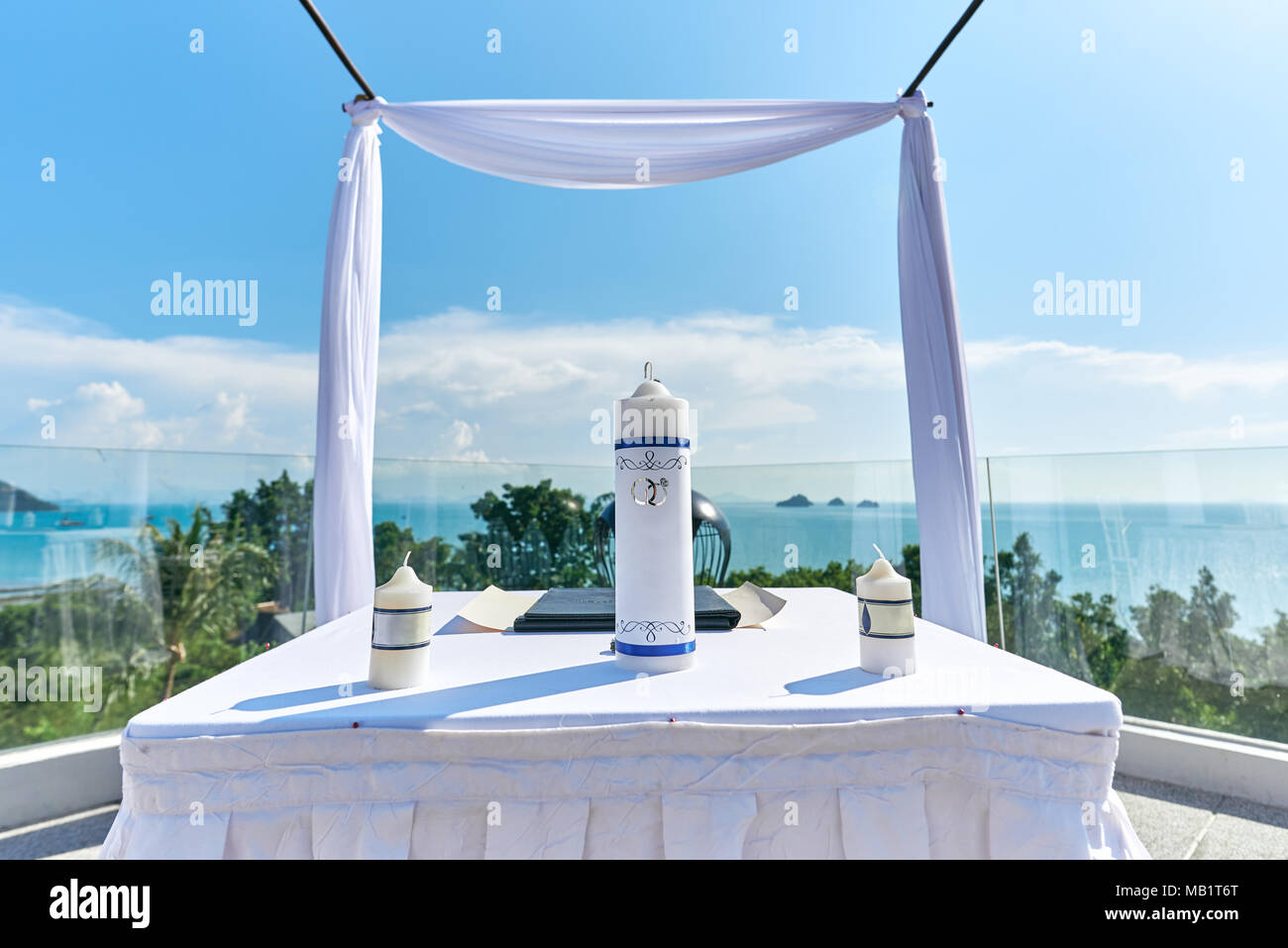 The wedding arch, altar setup with white table, The one big and two ...