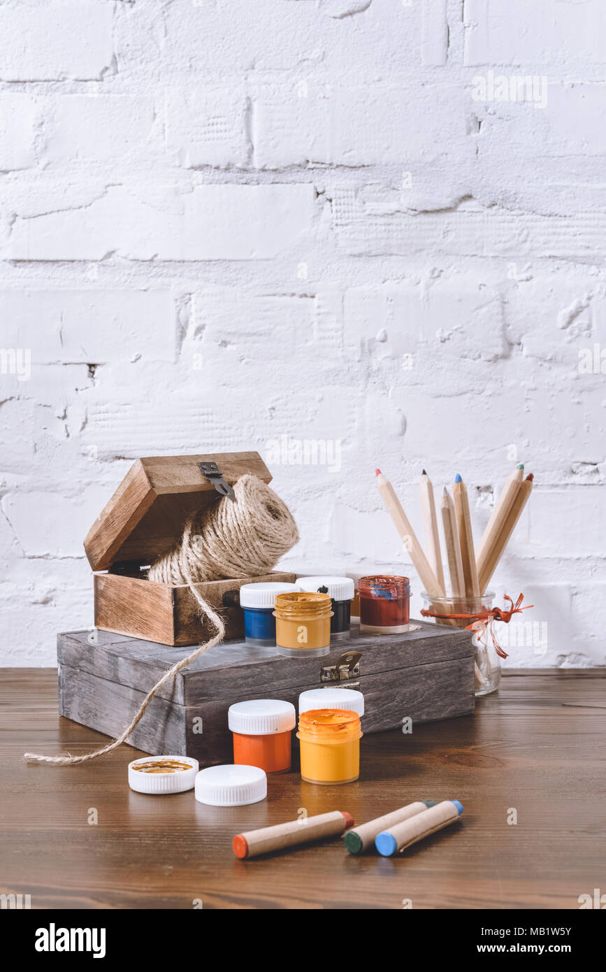 poster paints and wooden boxes on table Stock Photo - Alamy