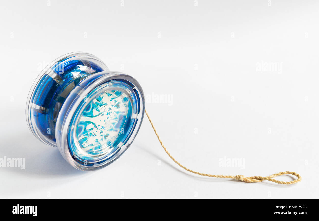 A blue yo-yo placed on a white background Stock Photo - Alamy