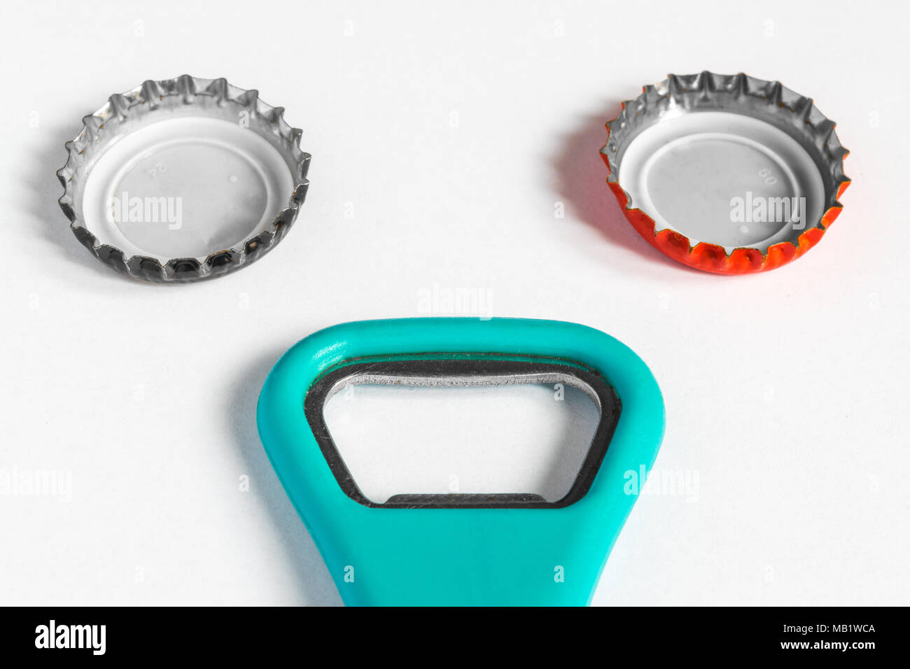 Two colored bottle caps and a bottle opener form a face Stock Photo - Alamy