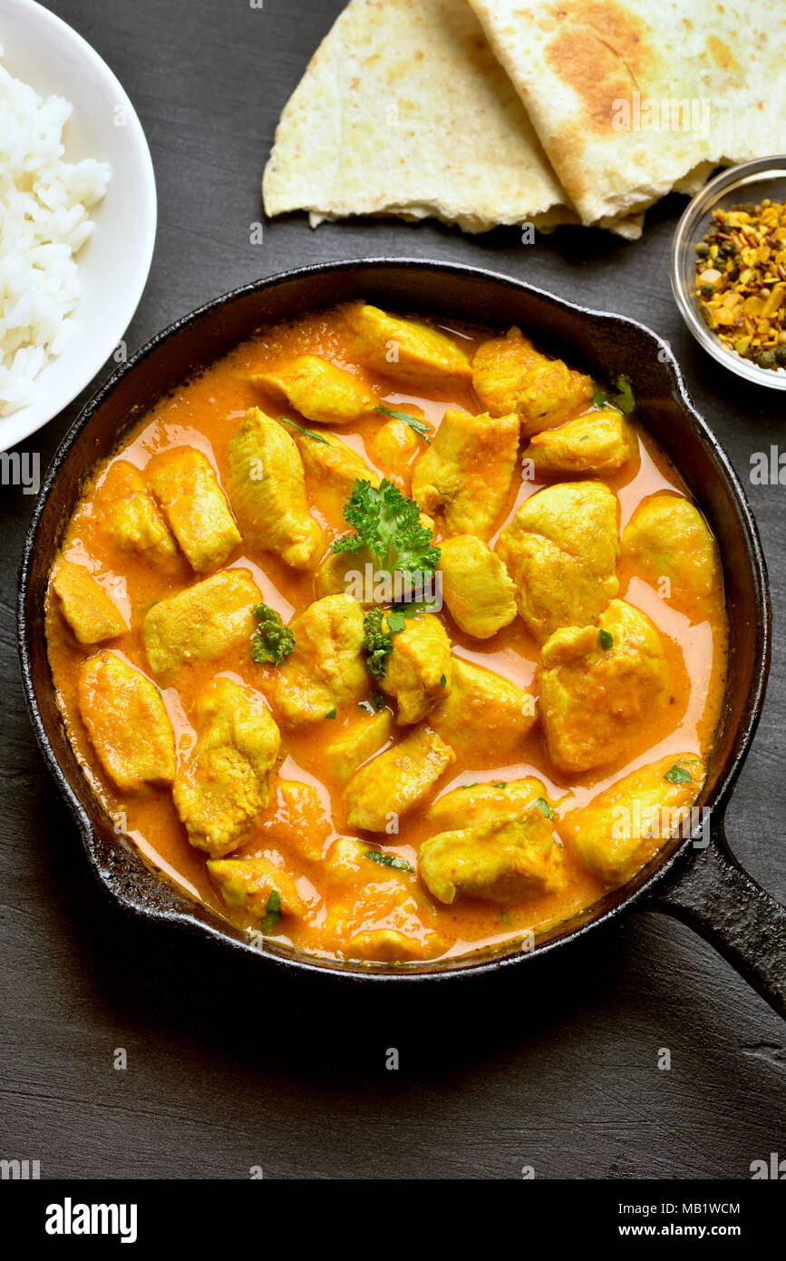 Indian chicken curry on black stone background. Top view, flat lay ...