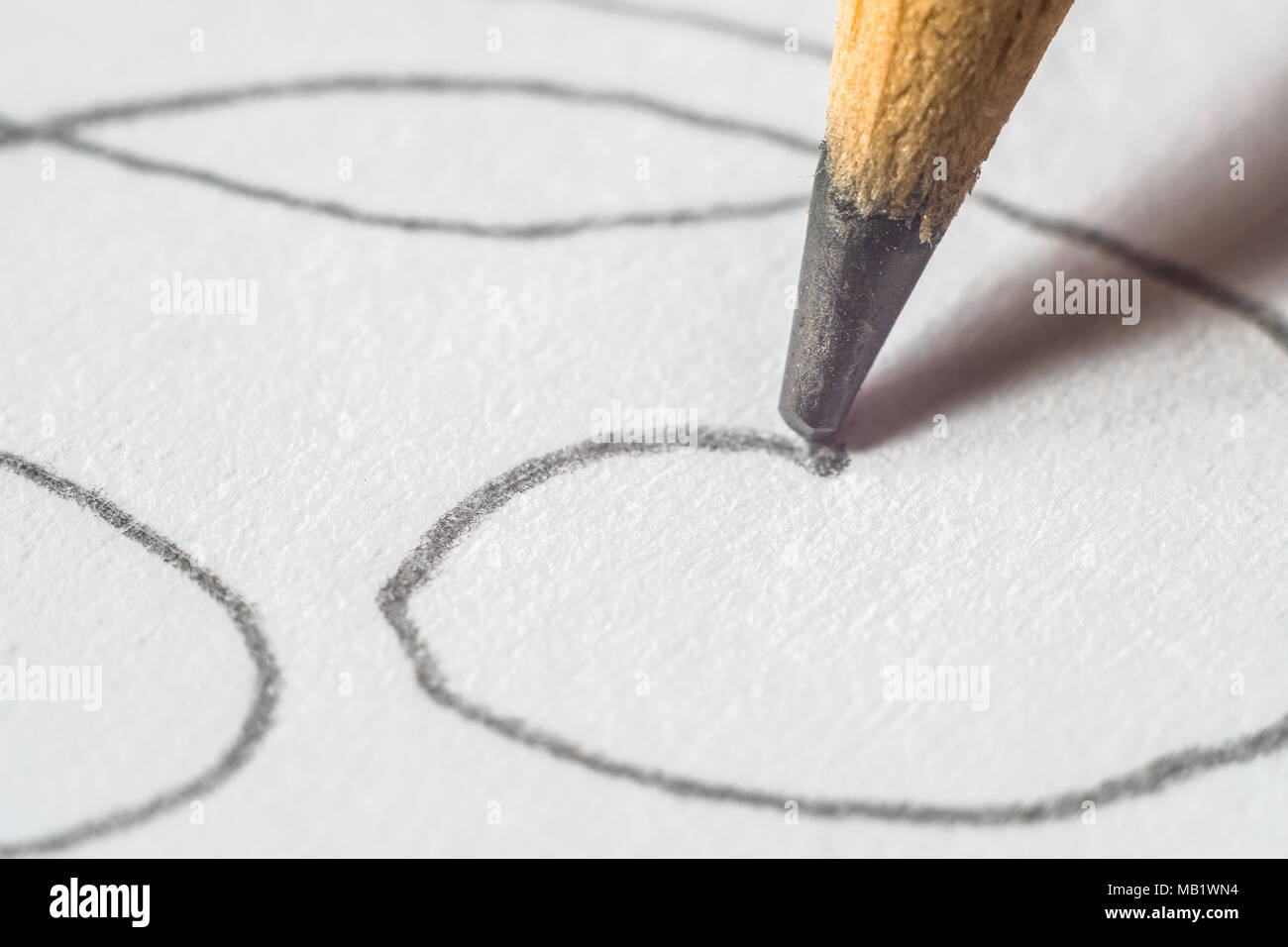 A tip of a pencil drawing lines on a white paper Stock Photo - Alamy