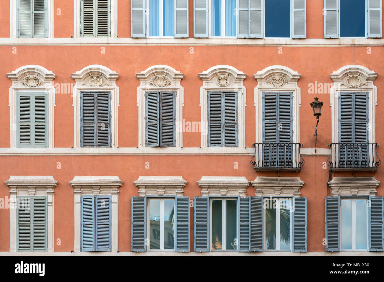 Windows and shutters on a terracotta coloured building in Piazza del ...