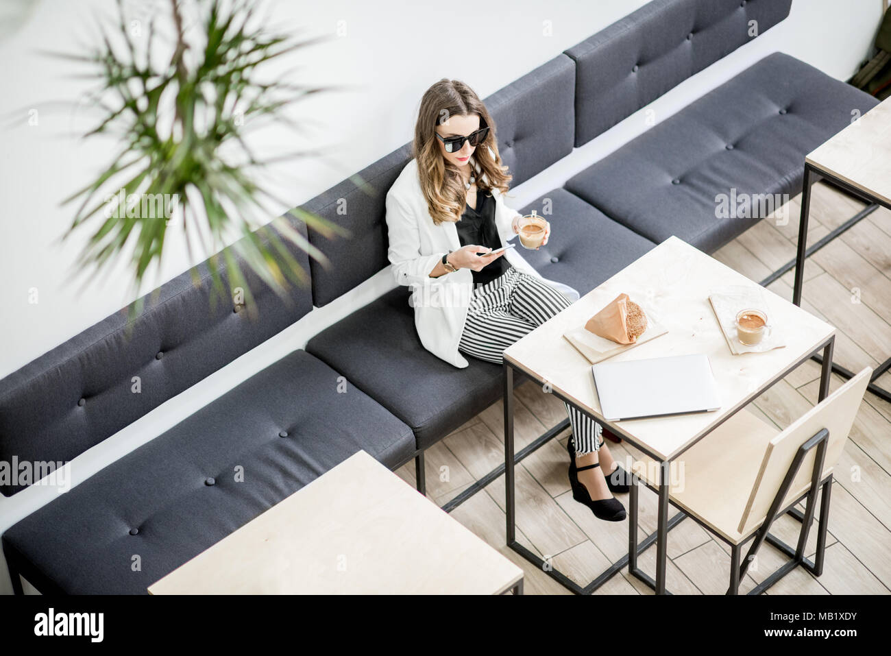 Business woman sitting during the coffee break in the modern cafe ...