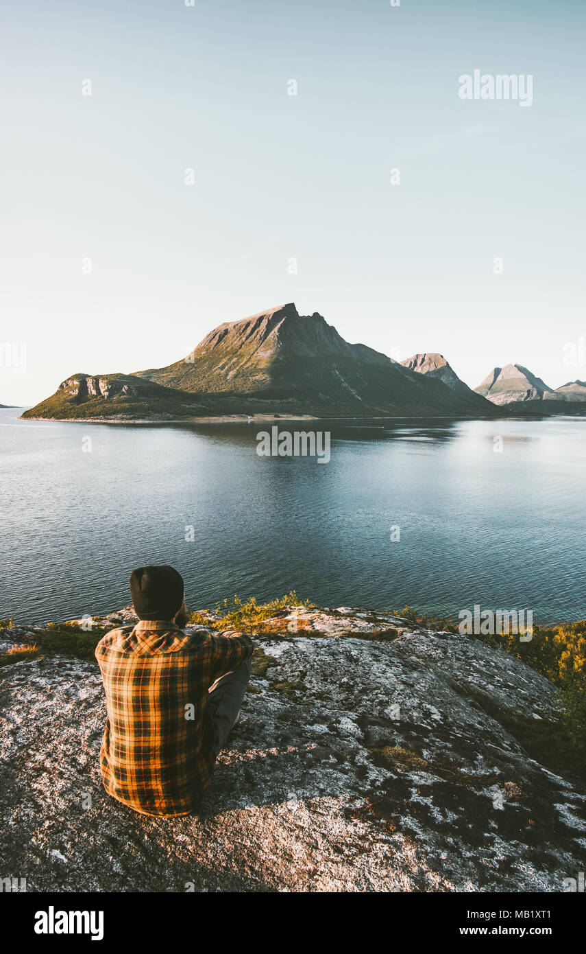 Traveler Man sitting alone admiring sea and mountains view Travel ...