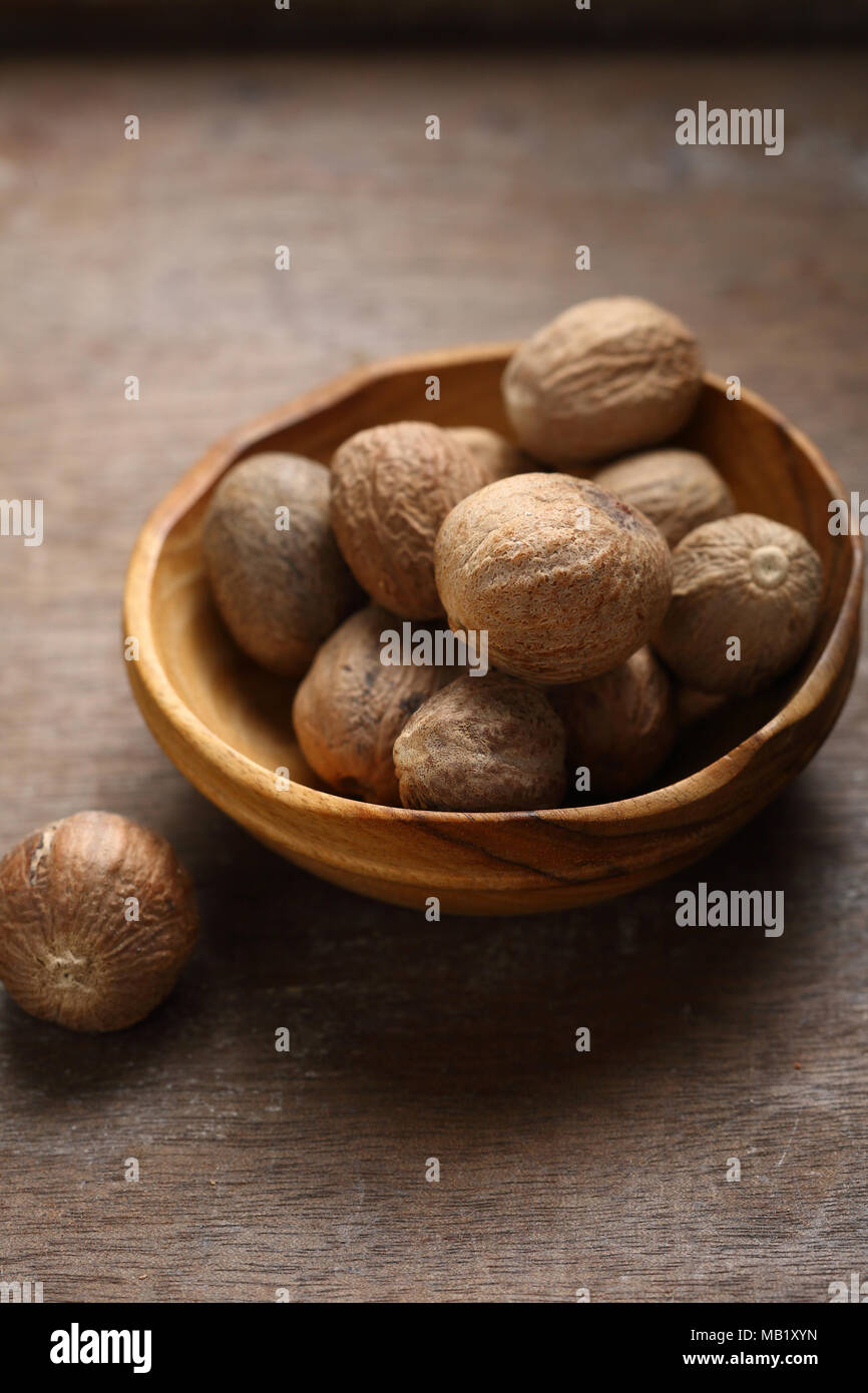 Nutmeg in wooden bowl hi-res stock photography and images - Alamy