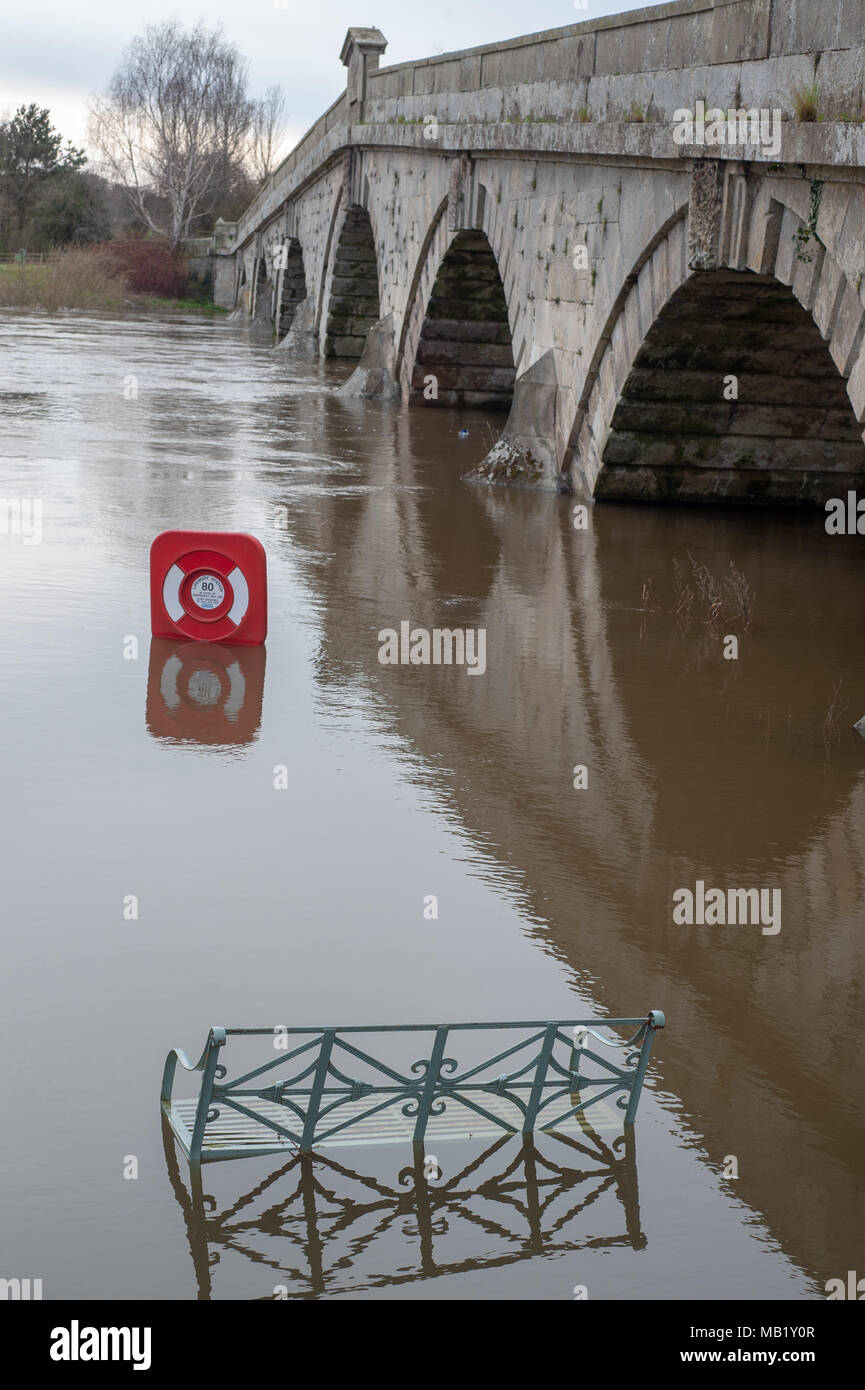 Bench on the riverbank at Atcham's Mytton and Mermaid hotel inundated ...