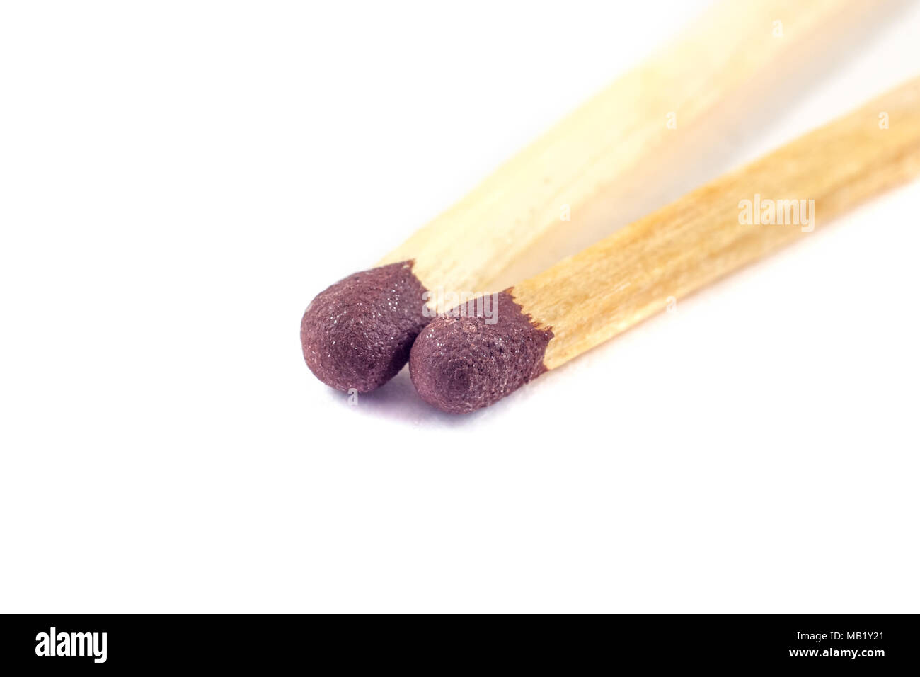Two match sticks isolated on white background Stock Photo - Alamy