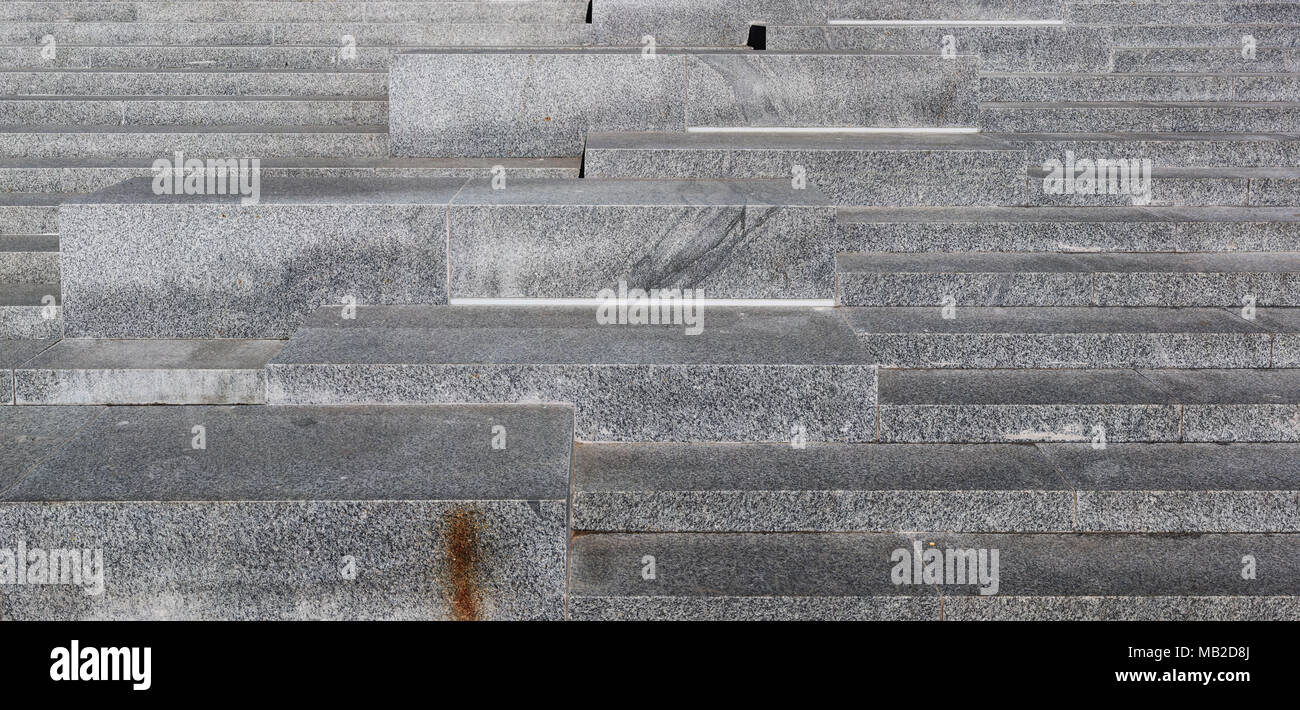 Steps of a ladder made of gray granite lead upward. Outdoor sunny day ...
