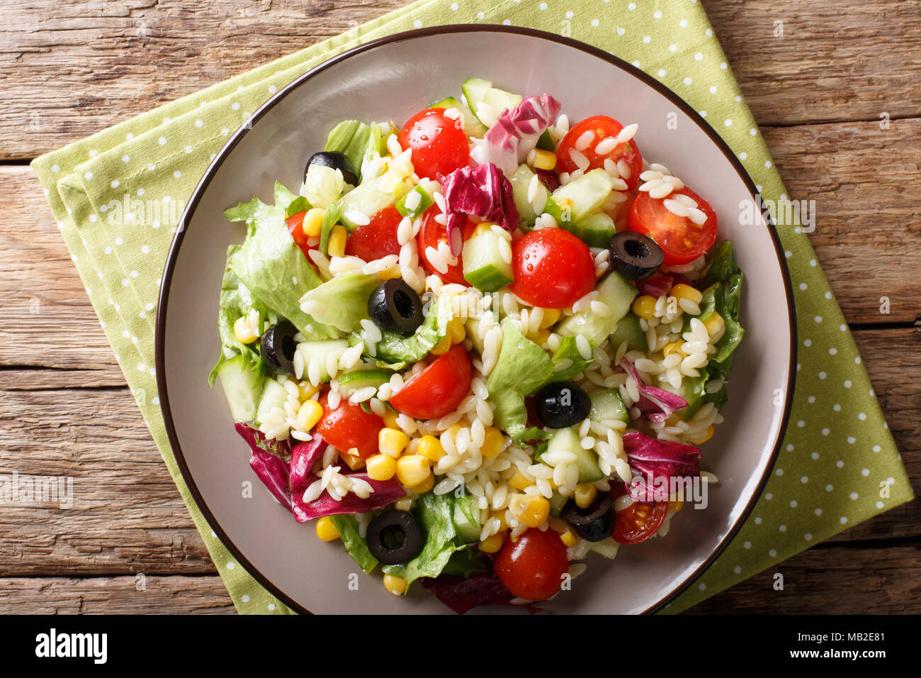 Vegetarian meal: vegetable salad with rice close-up on a plate on a ...