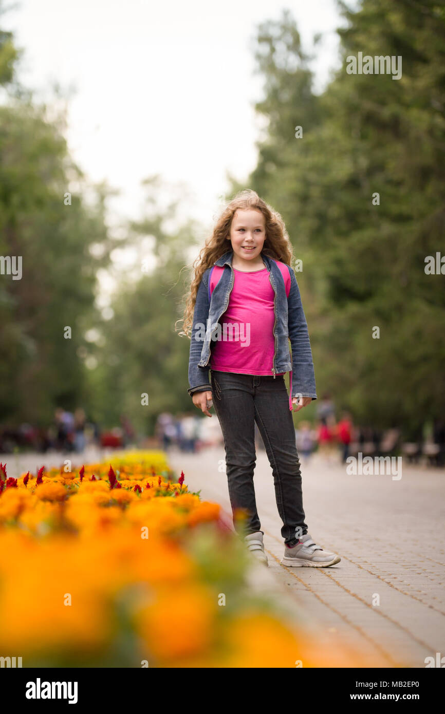Pretty smiling child girl walking in park Stock Photo - Alamy