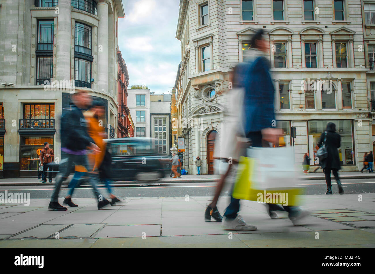 Motion blurred shoppers walking down high end London high street Stock ...
