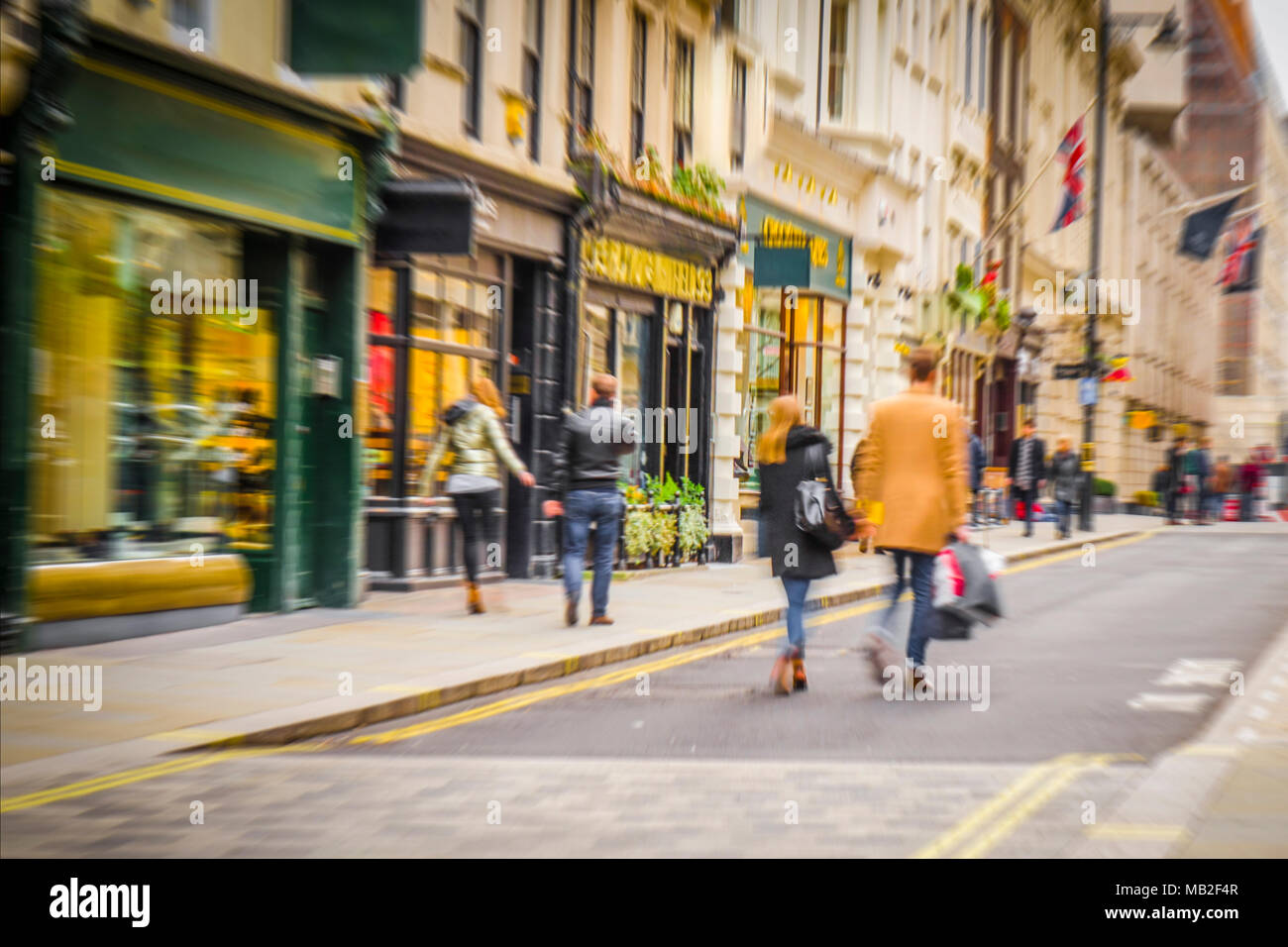 Motion blurred shoppers walking down high end London high street Stock ...
