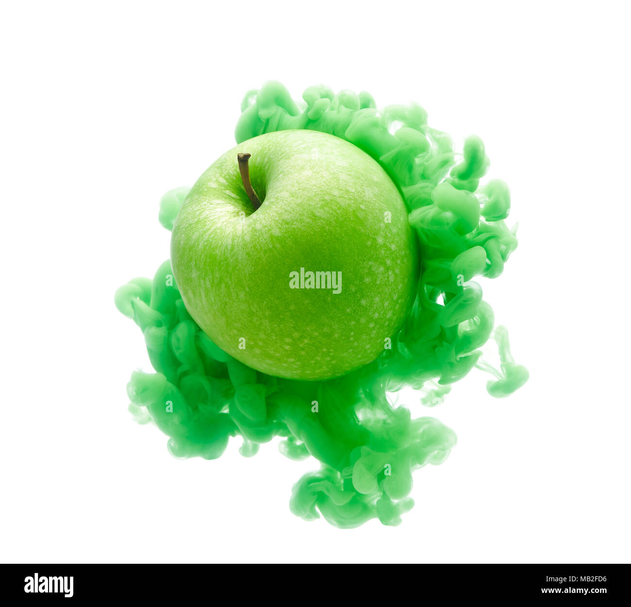 Green apple on ink isolated over white background Stock Photo - Alamy