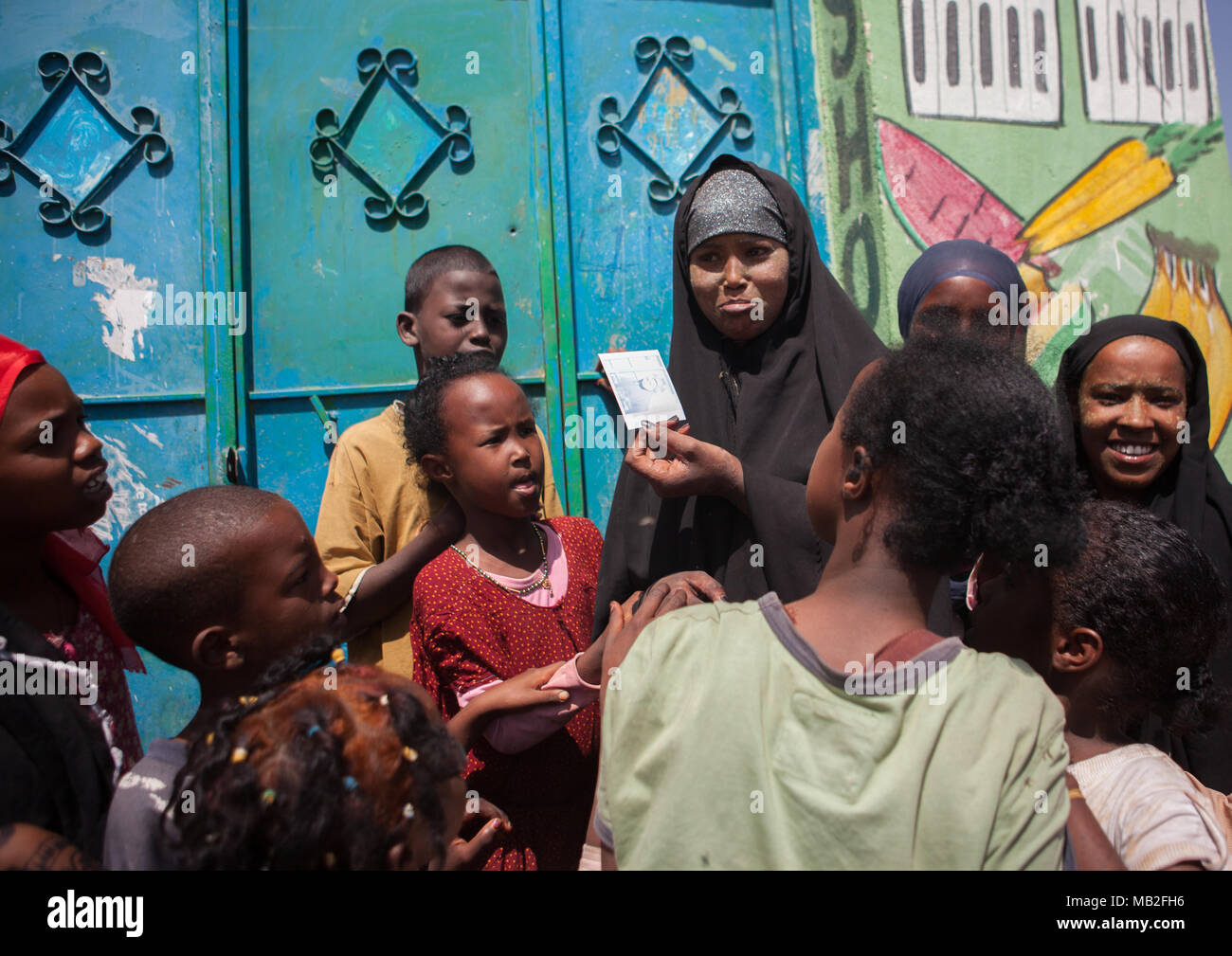 Somali girl discovering her picture on a polaroid, Woqooyi Galbeed ...
