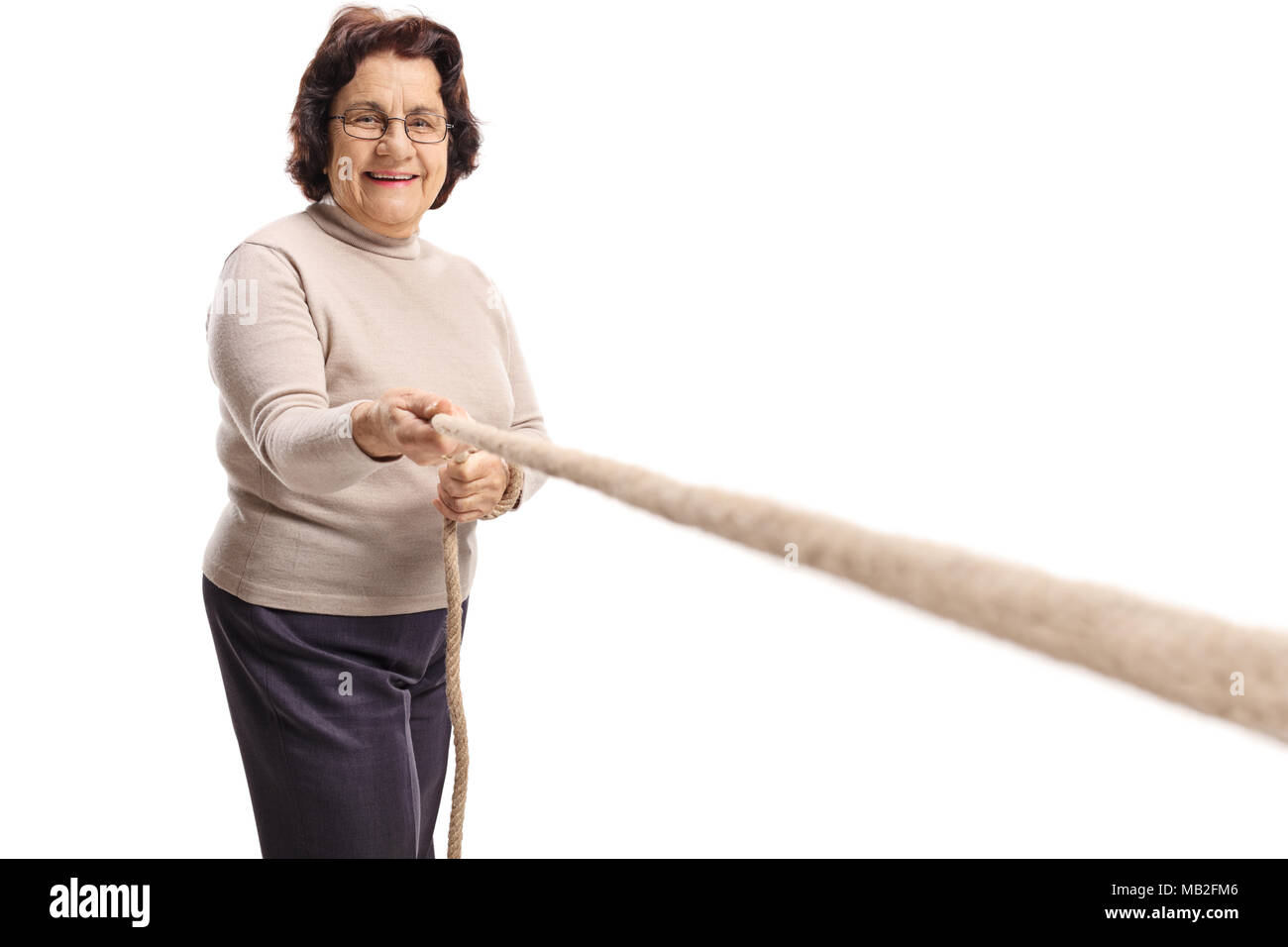 Elderly woman pulling a rope isolated on white background Stock Photo ...