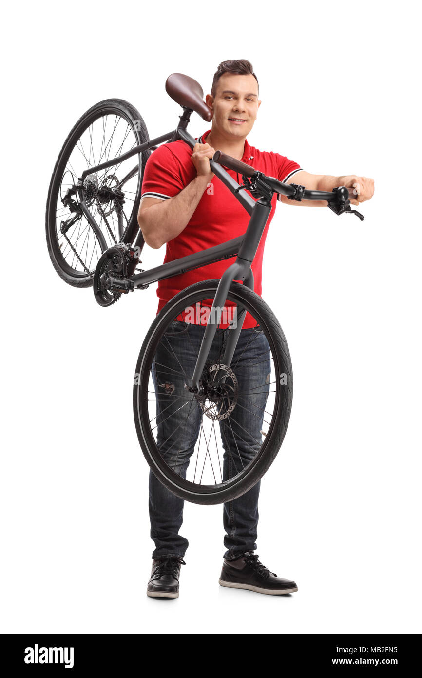 Full length portrait of a young man holding a bicycle on his shoulder ...