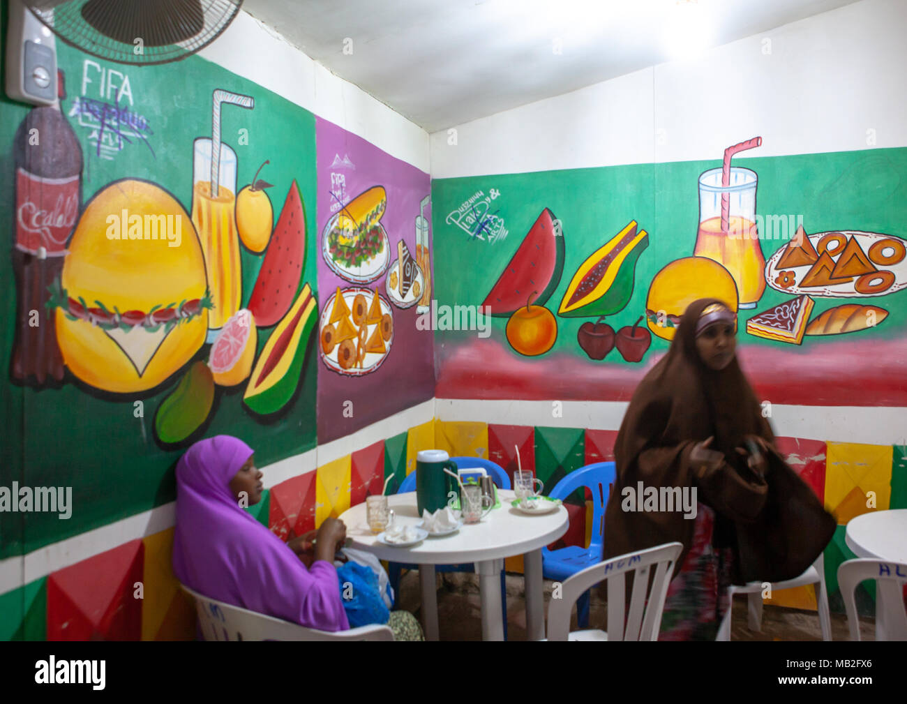 Somali women inside a restaurant with decorated walls, Woqooyi Galbeed ...