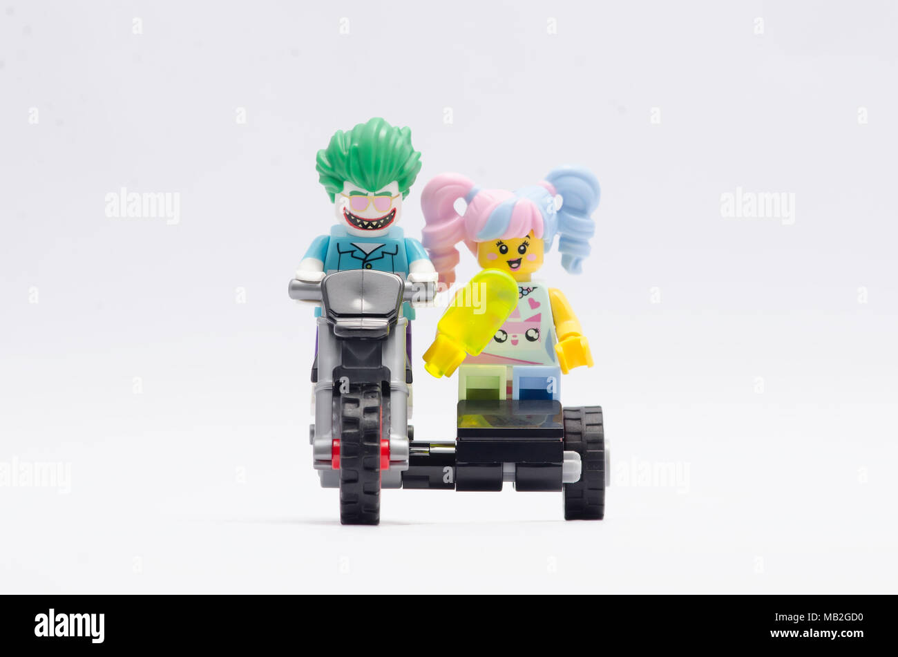 mini figure of joker and n-pop girl riding motorcycle. isolated on ...