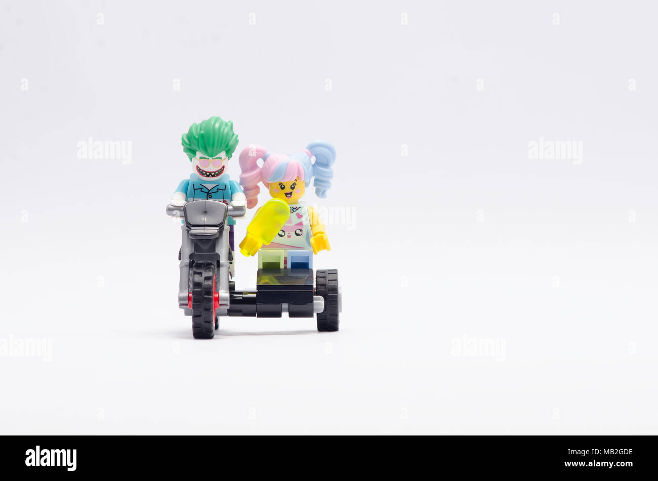 mini figure of joker and n-pop girl riding motorcycle. isolated on ...