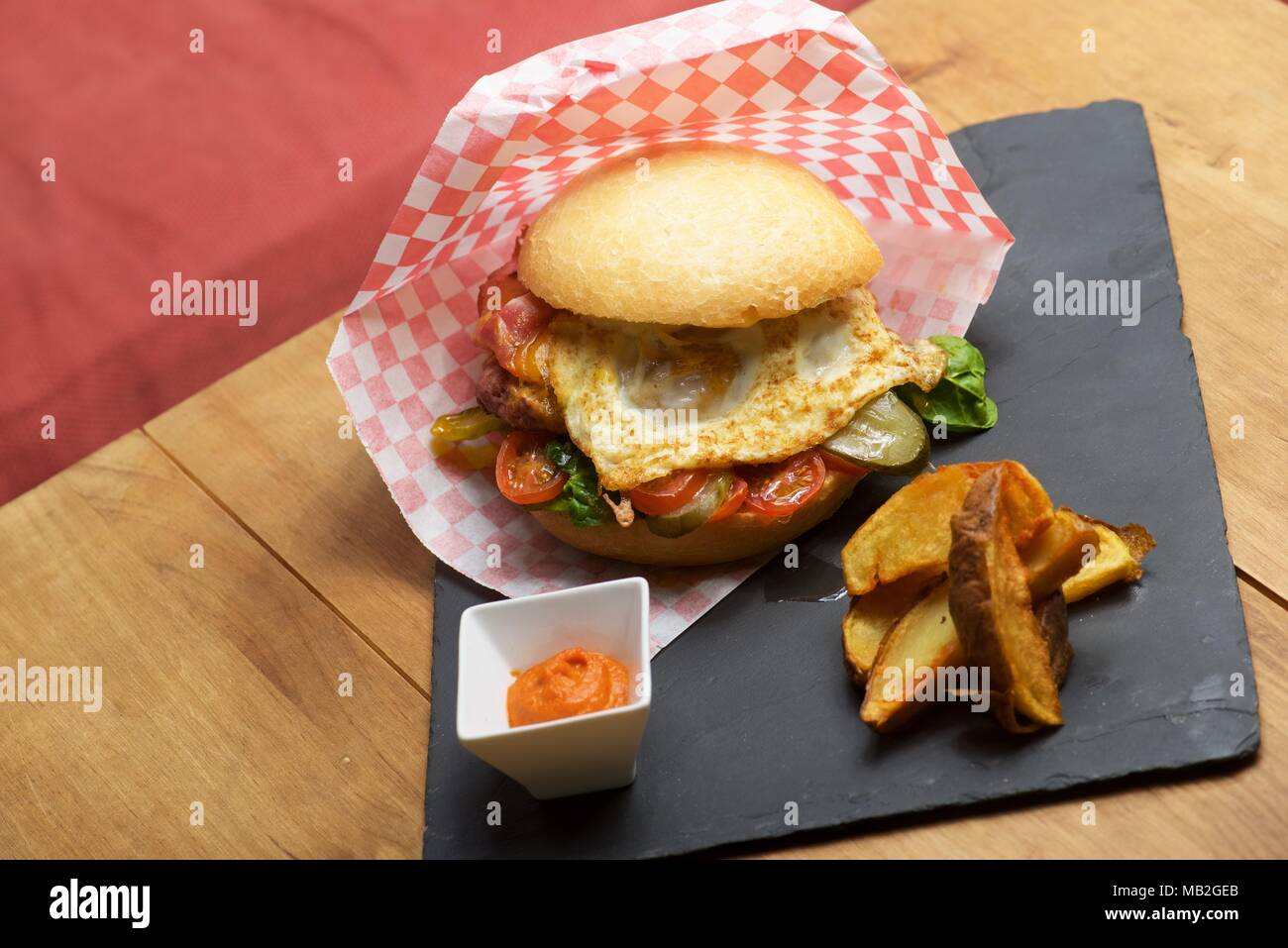 Beef burger with fried egg and chips Stock Photo - Alamy